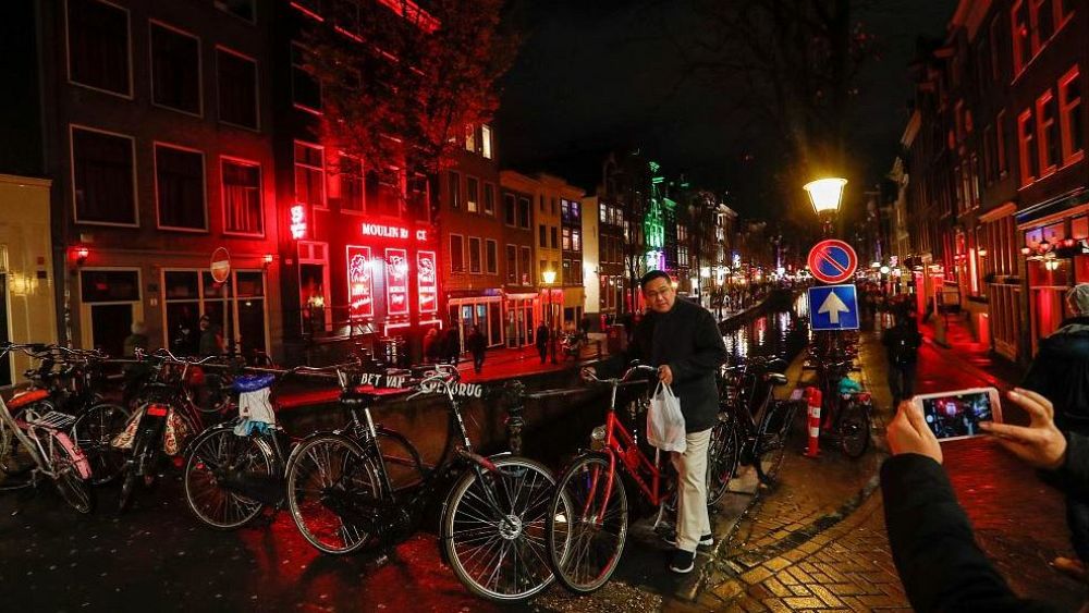 'Tourists must have their backs turned to red light district windows ...