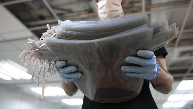 Volunteers turn recycled plastic into face shields around the world ...