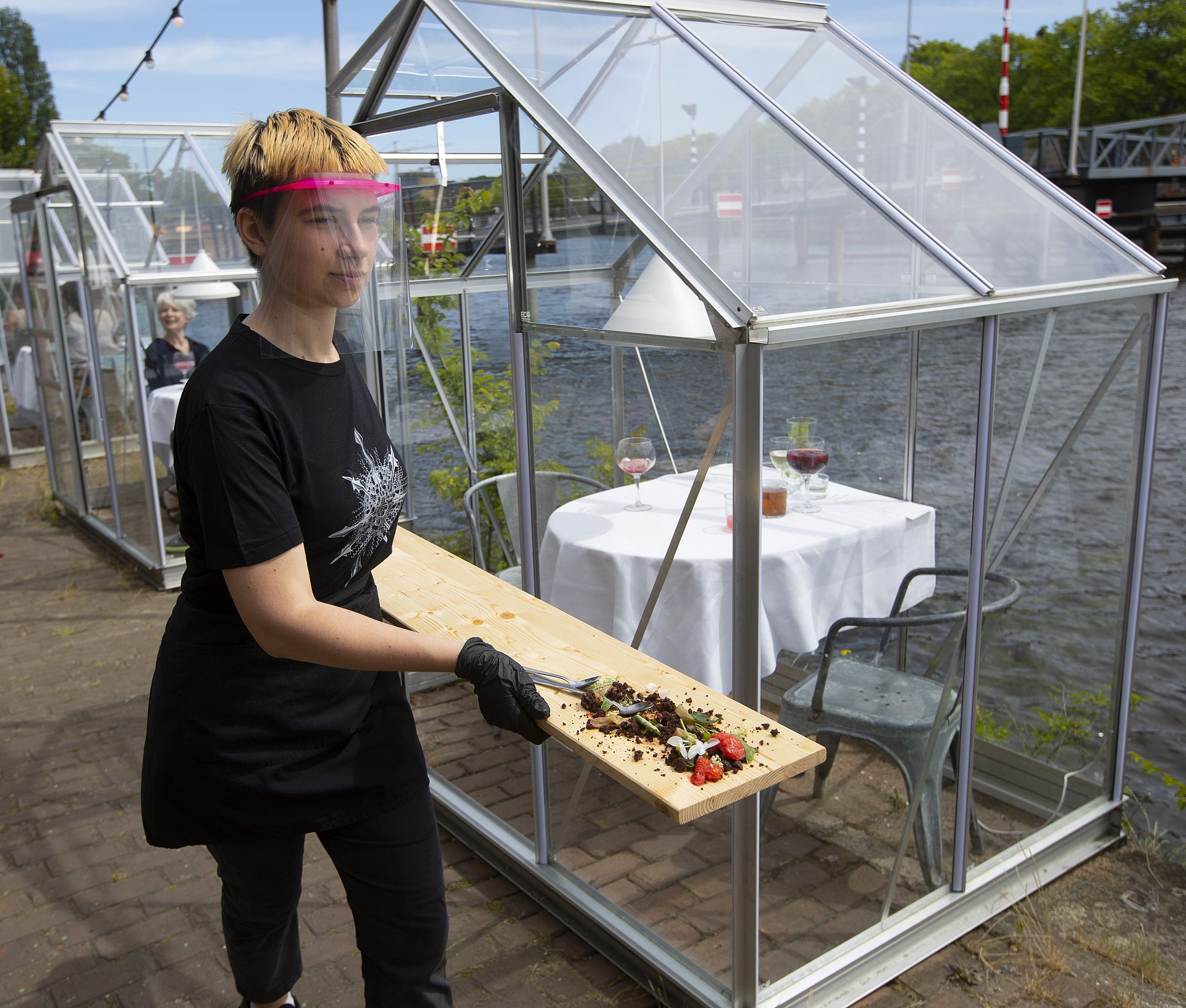 In pictures: Restaurants find creative ways to enforce social ...
