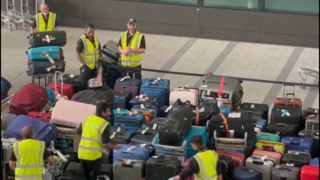 Chaos at Heathrow Airport as a baggage system malfunction causes pile ...