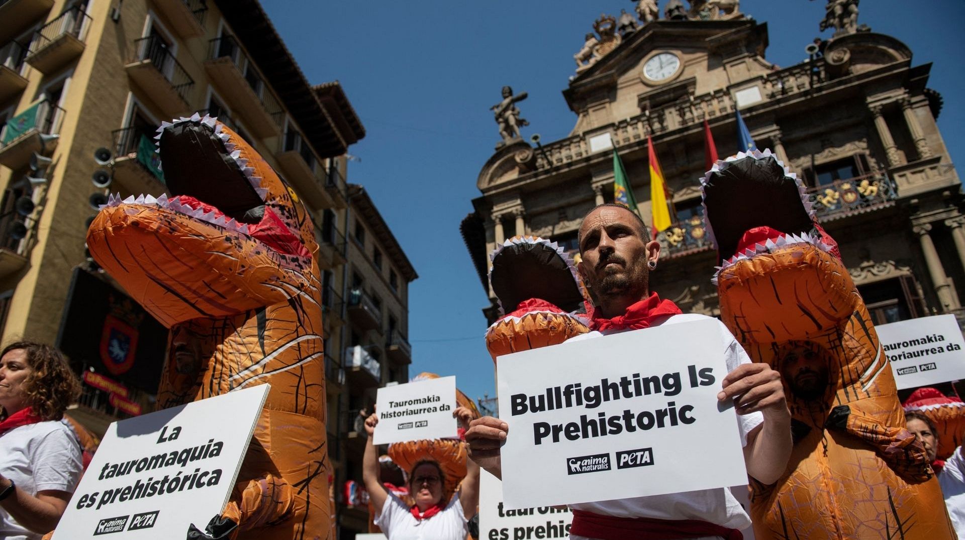 Running of the Bulls: Activists dressed as dinosaurs protest ...