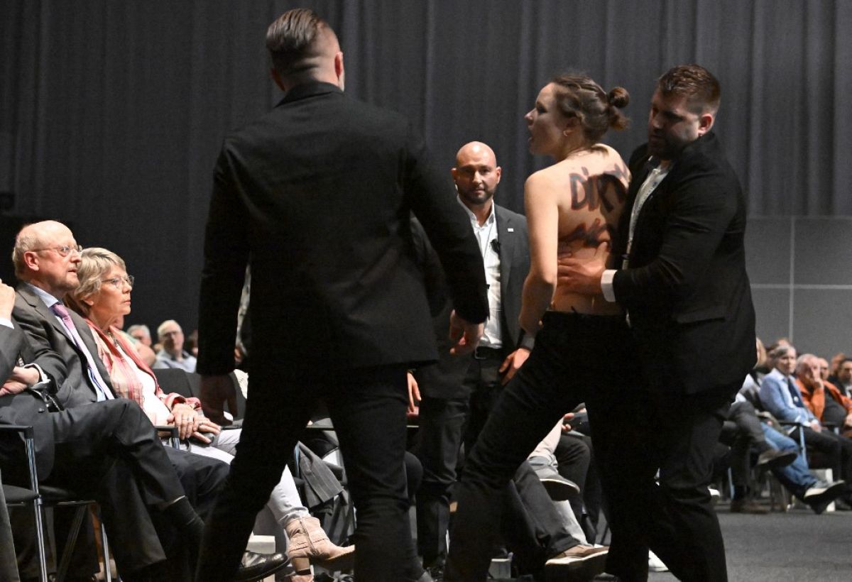In pictures: Topless protester and cake throwing disrupt Volkswagen’s ...