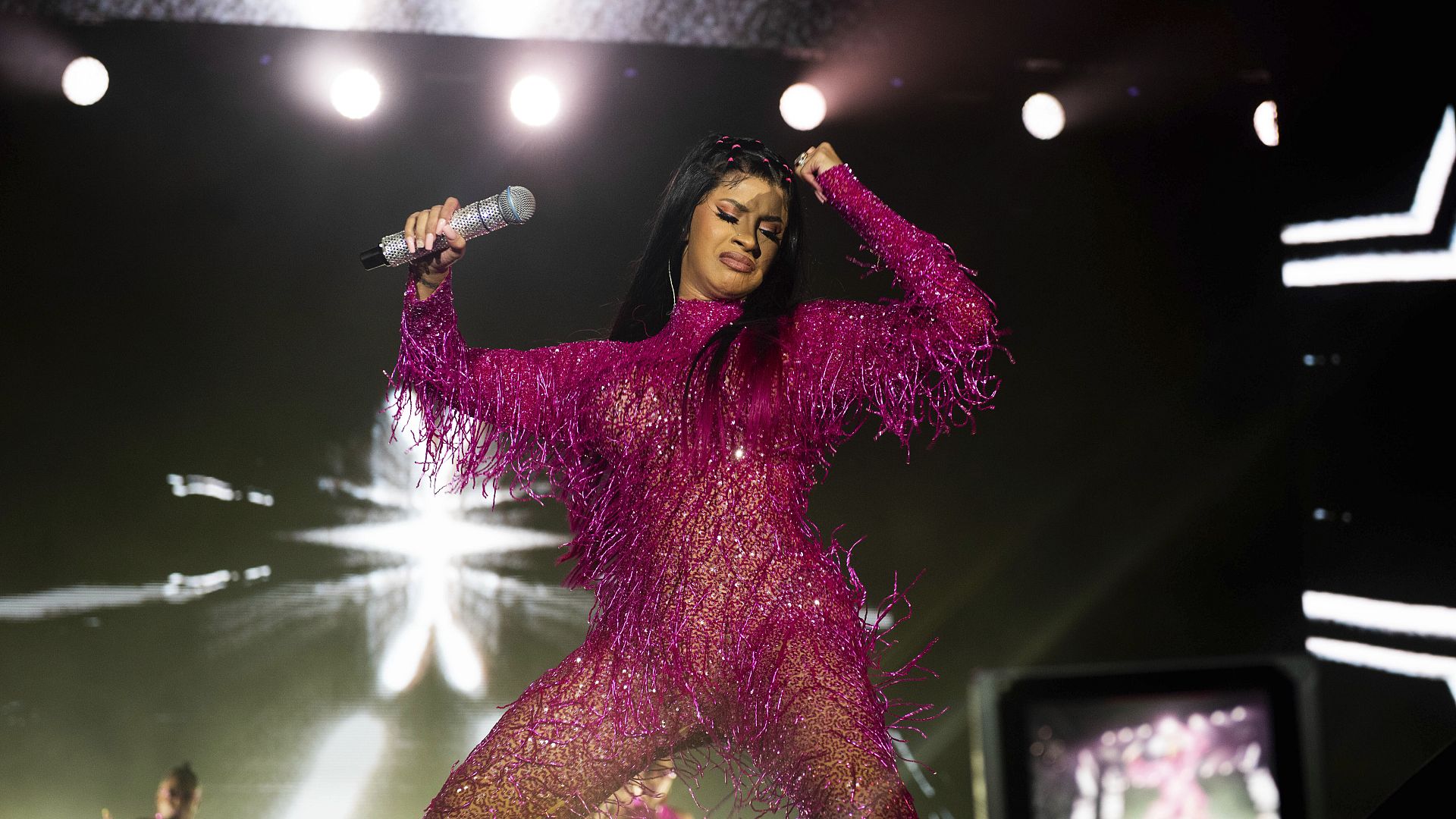 Cardi B throws microphone at audience member who threw a drink on her ...