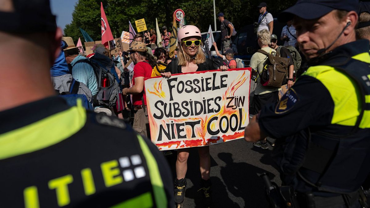 Dutch police fire water cannons and detain thousands of protesters in ...