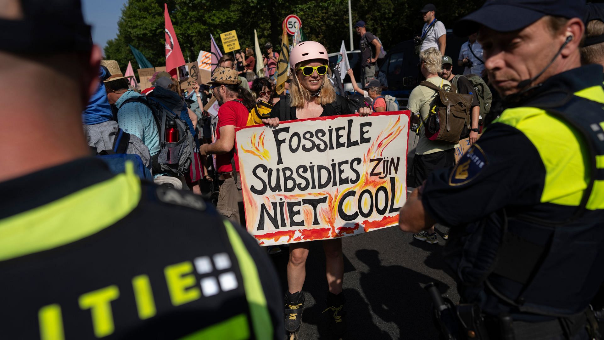 Dutch police fire water cannons and detain thousands of protesters in ...