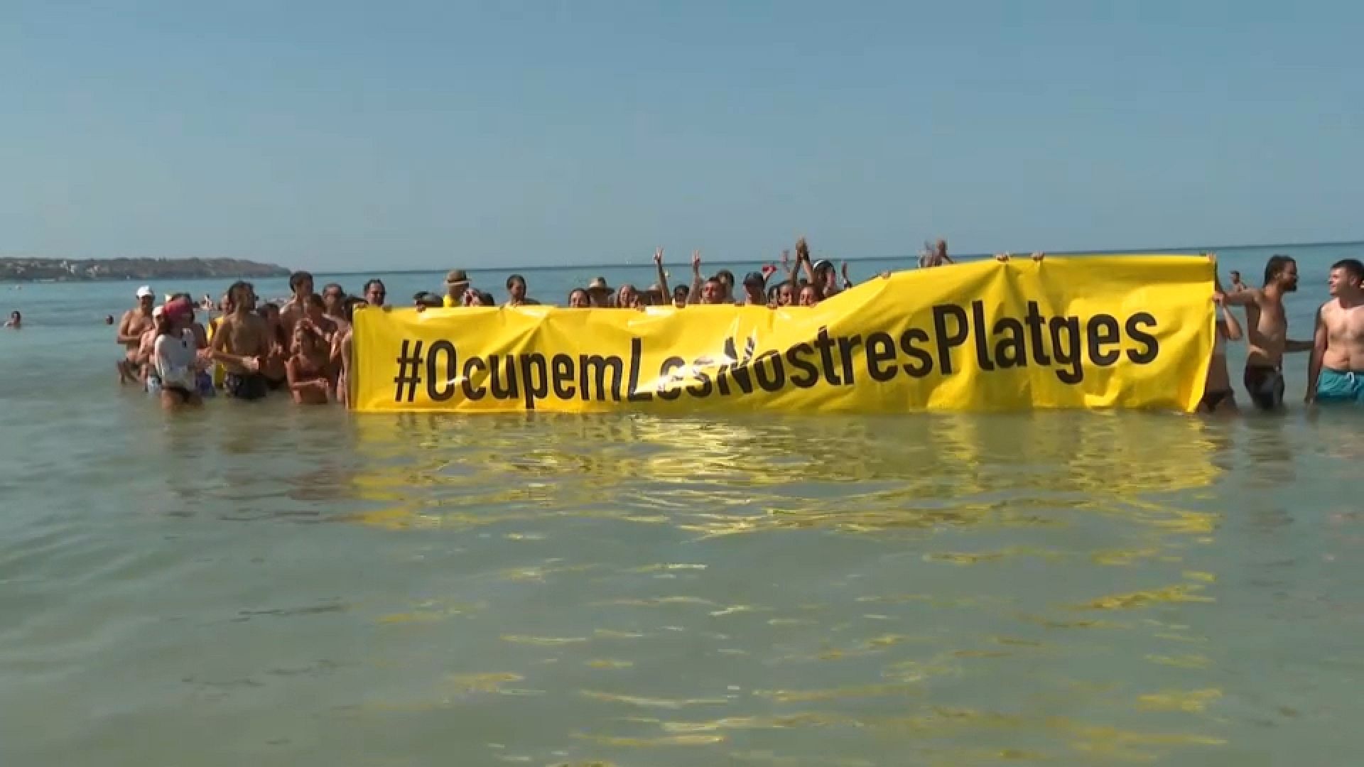 Overtourism protesters take over popular Mallorca beach demanding ...