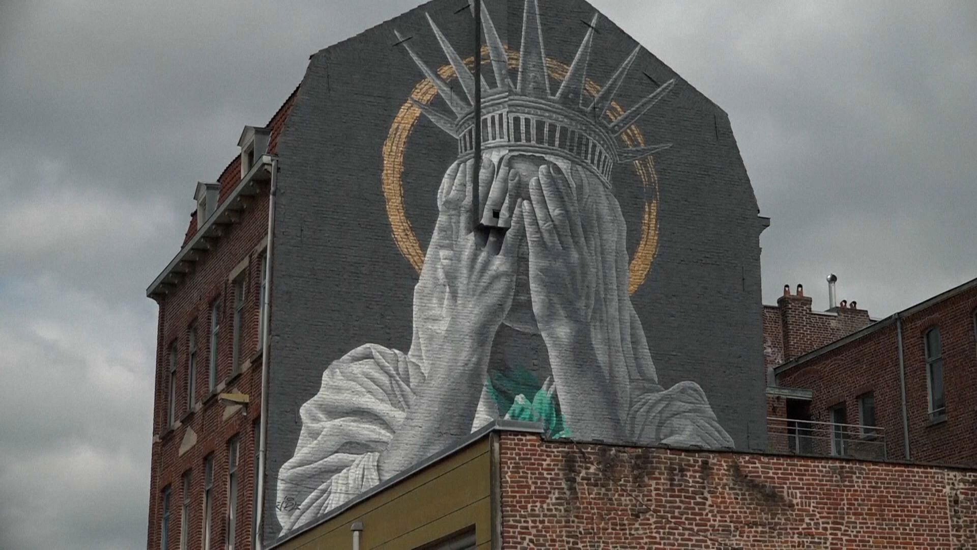Video. Giant mural in France critiques Trump's immigration policies ...