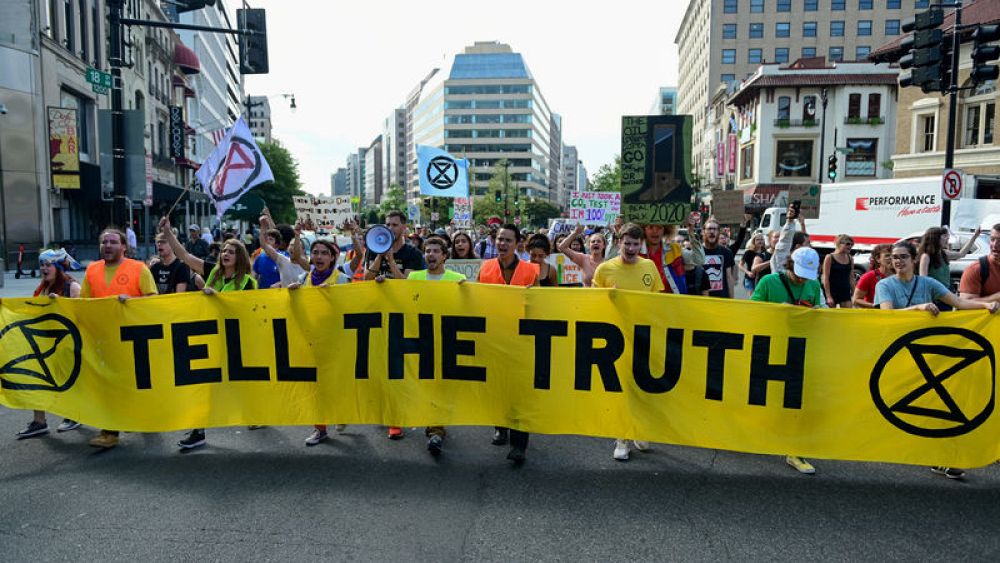 Climate activists block traffic in U.S. capital, chain themselves to ...